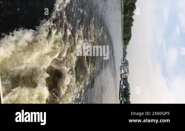 Vertical video. Rear view of waves behind the speedy boat of fast ...