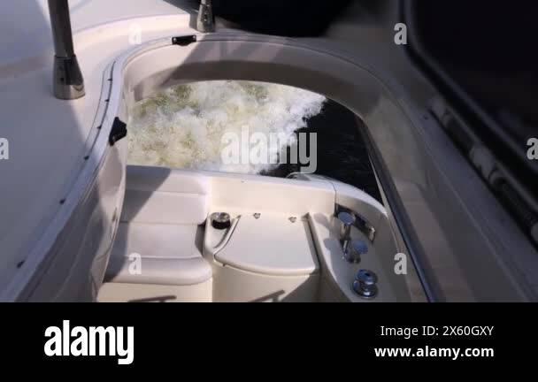 Rear view of waves behind the speedy boat of fast moving. Ocean water ...