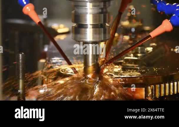 The CNC milling machine rough cutting the mold parts with liquid ...