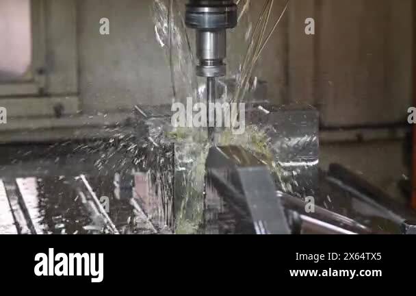 Close up scene the CNC milling machine cutting the mold parts with oil ...