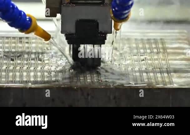 The graphite electrode working on EDM machine with liquid coolant ...