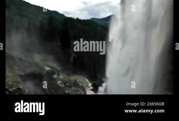 flow of water from the waterfall with drops and splashes in a pine ...