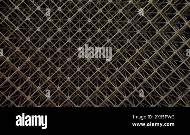 A close-up view of a dense metal grid structure, showcasing intricate ...