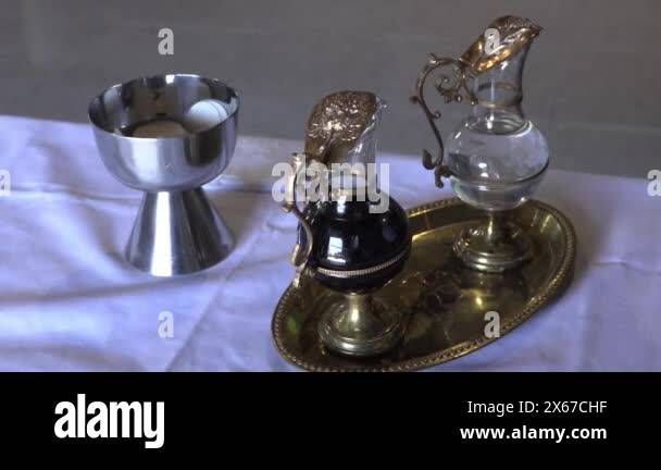 Communion. Moment of the consecration of the cup with wafers and jug ...