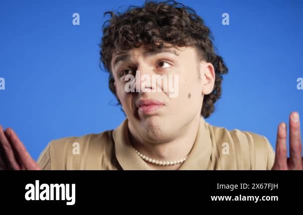 Confused man, shoulders up - cant help, makes gesture of I dont know ...