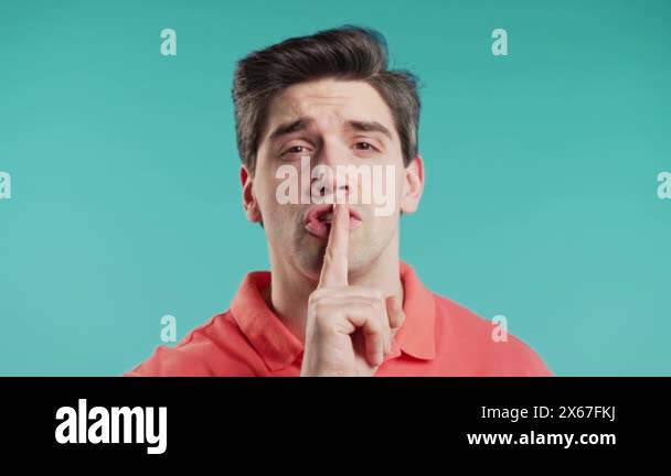 Handsome european brunette guy with gesture of shhh, secret, silence ...