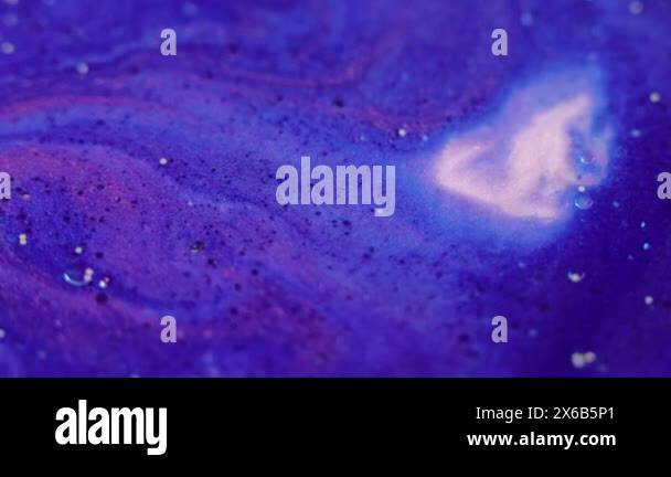 Paint foam. Ink spill. Sparkling liquid. Defocused blue purple color ...