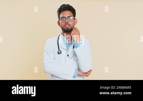 Eureka. Inspired Indian young doctor cardiologist man pointing finger ...