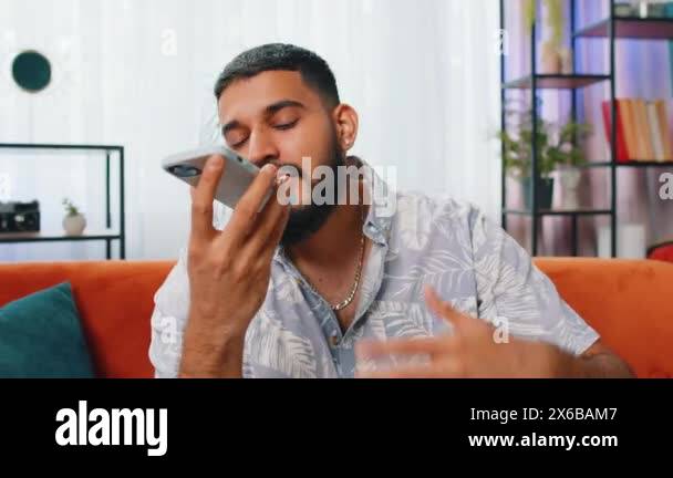 Happy excited Indian man making phone call conversation with friends at ...