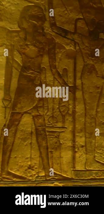 A young tourist visiting the sculptures inside the temple of Abu Simbel ...