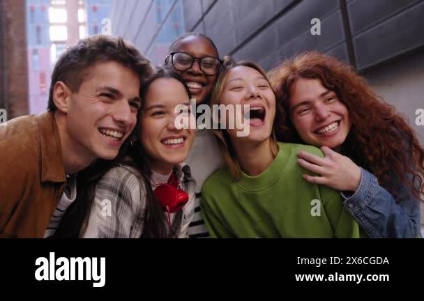 Multiracial group student people hugging looking excited at something ...