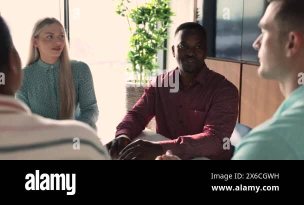 Multicultural international staff talking, engaged in teamwork in ...