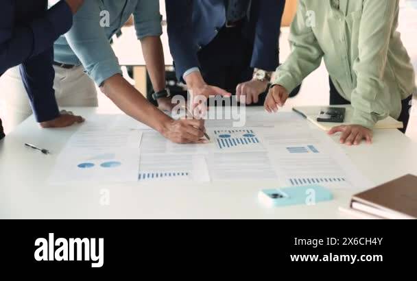 Businesspeople analyzing report shown in charts, graphs and diagrams ...