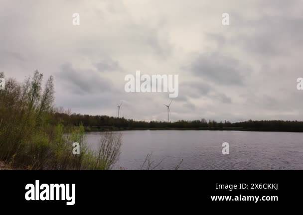 This video captures the peaceful scenery of a tranquil lake with wind ...