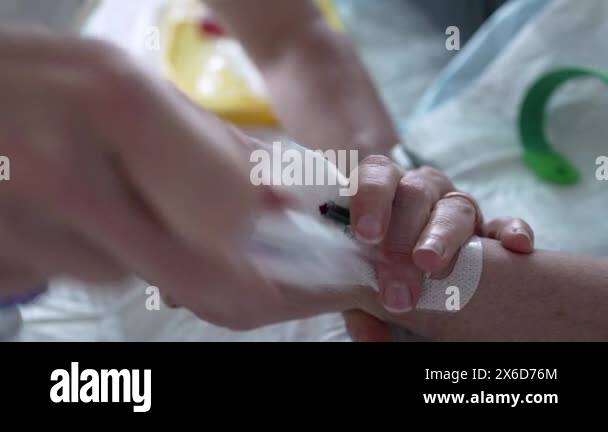 Nurse hand applying medical drip into Patient's hand with IV catheter ... Nurse hand applying medical drip into Patient's hand with IV catheter ...