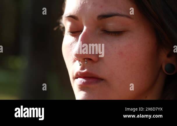 Contemplative young millennial girl face meditating outside. Pensive ...
