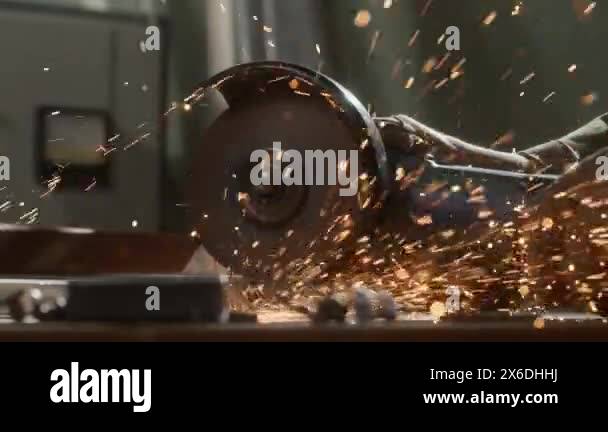 Worker using grinder machine cutting steel material. Craftsman working ...