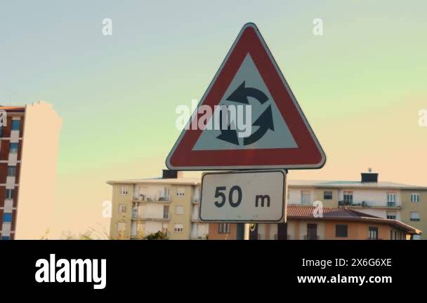 Roundabout sign with a plate indicating 50 meters, indicating that ...