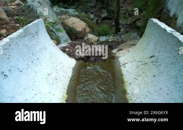Drainage system in the forest. Water flowing through the channel ...