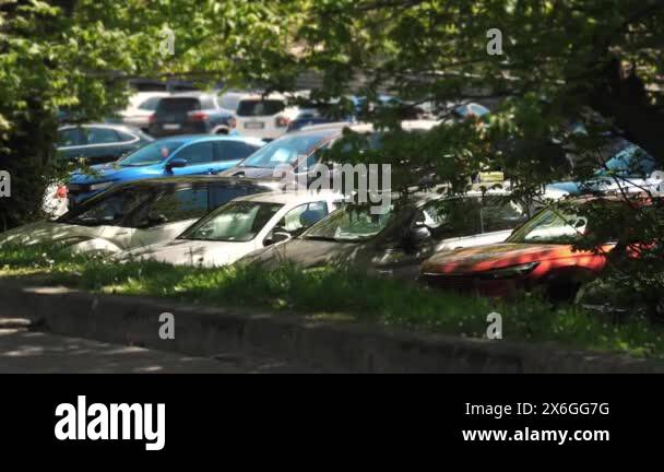 The photo showcases a crowded outdoor parking lot, densely packed with ...