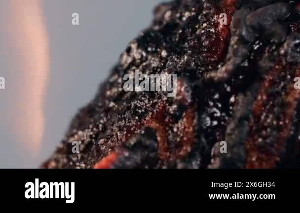 An ignited meal burns and melts in the flame, blows bubbles and boils ...