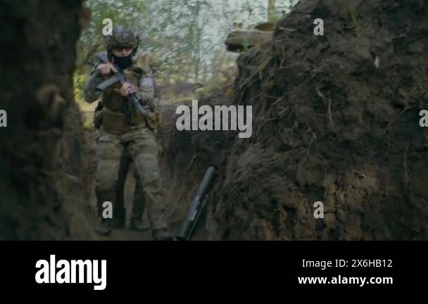 Two male soldiers or military men in camouflage uniform and helmets ...