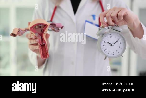 Woman shows vintage alarm clock as sign of urgent treatment of uterine ...