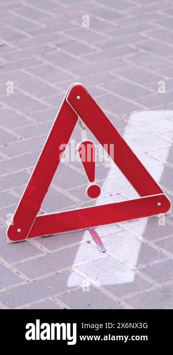 Car accident red warning sign stands asphalt signaling danger caution ...