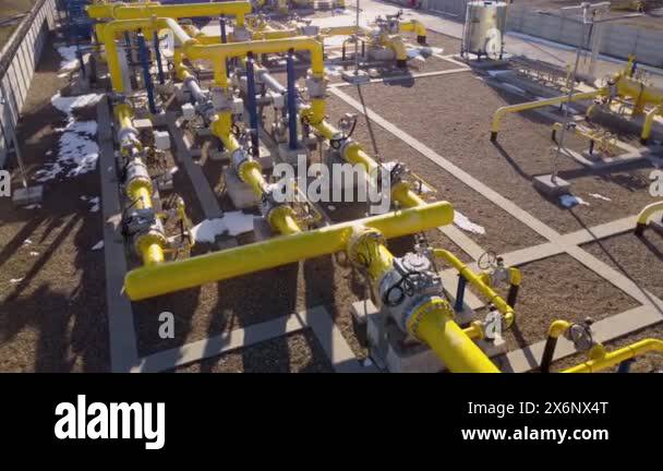 Industrial setting yellow pipes snake way across terrain transporting liquids vital ...