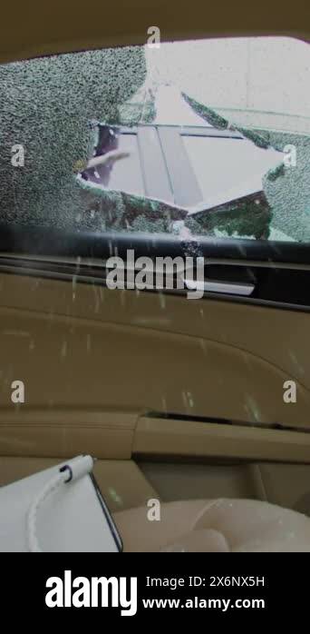 Person thief in hood smashes car window swiftly grabbing bag through ...