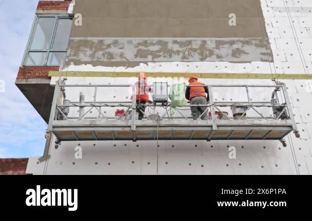 Construction Workers Insulating Building Facade,Two construction ...