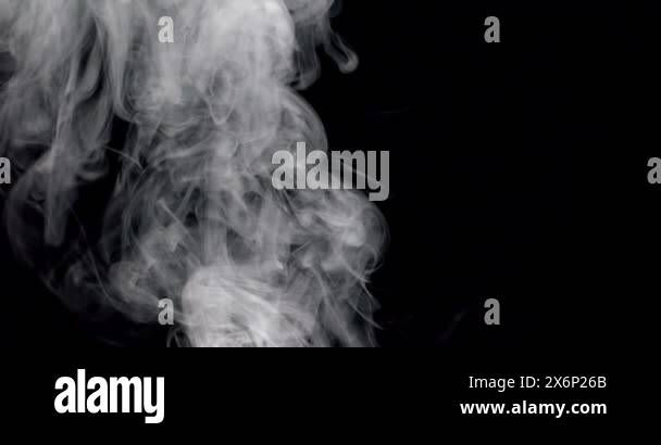 A close-up of white smoke forming abstract shapes and patterns in slow ...