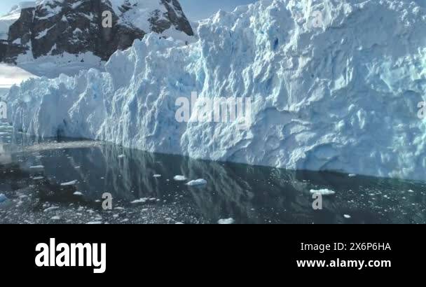 Giant glacier towering cold arctic ocean. Massive iceberg floating ...