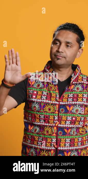 Vertical video Indian man trying to stop chaotic fight using calming ...