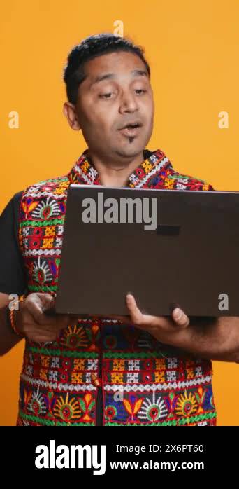 Vertical video Indian man having entertaining conversation with friends ...