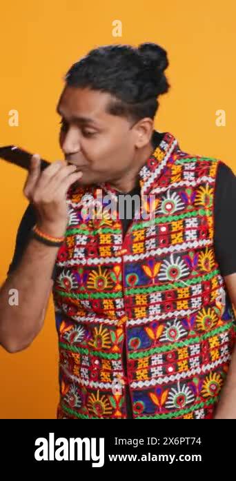 Vertical video Irked indian man fighting with friends during telephone ...