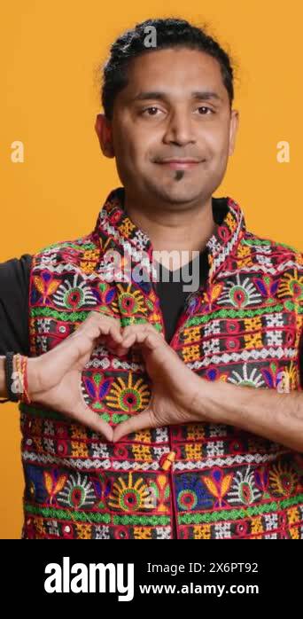 Vertical video Portrait of jolly friendly indian man doing heart symbol ...