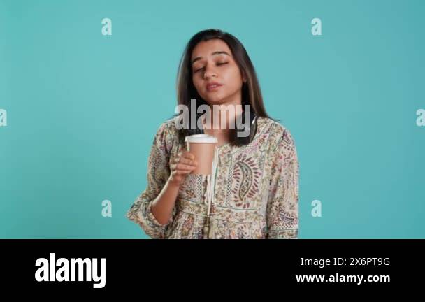 Sleepy woman yawning, sipping coffee to gain energy and get rid of ...