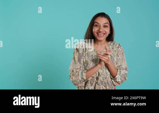 Joyful indian woman happily clapping hands, ecstatic about ...