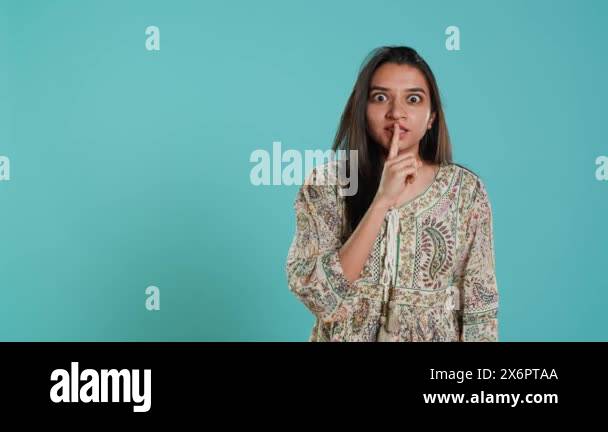 Annoyed indian woman doing shushing hand gesturing, irritated by noise ...