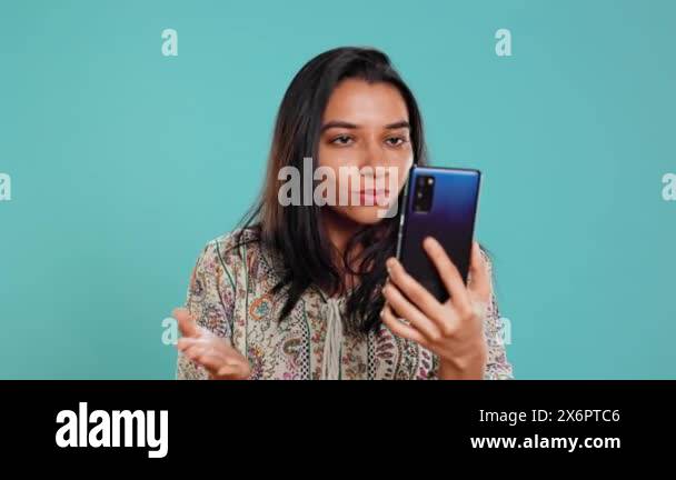 Irked woman fighting with friends during smartphone videocall, isolated ...