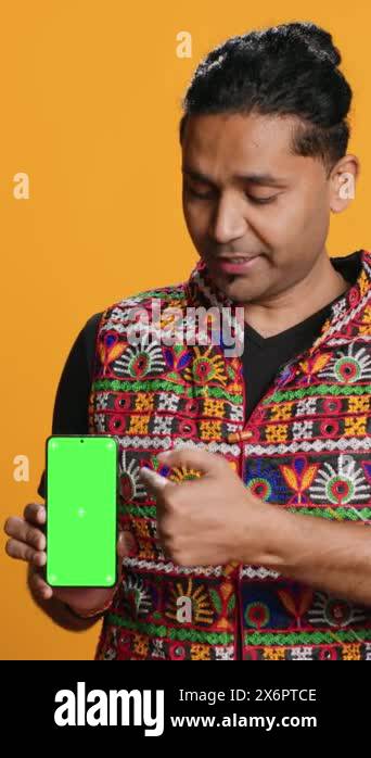 Vertical video Influencer presenting green screen mobile phone ...