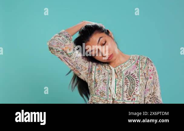 Portrait of cheerful friendly indian woman smiling, flipping long ...