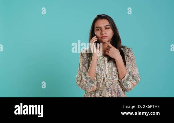 Indian woman talking with friends in phone call using smartphone ...