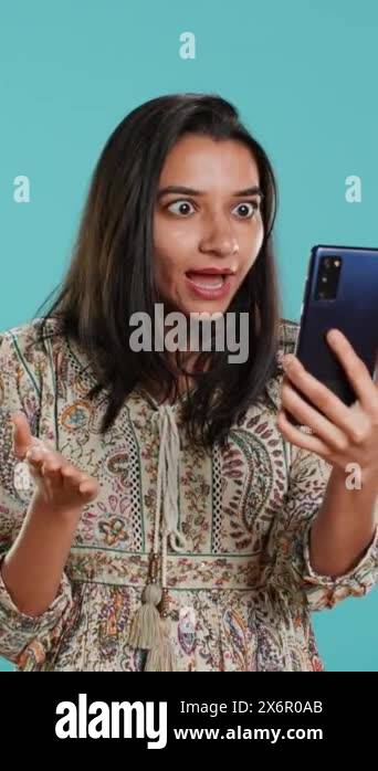 Vertical video Irked woman fighting with friends during smartphone ...