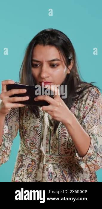 Vertical video Gamer with disappointed look on face after receiving ...