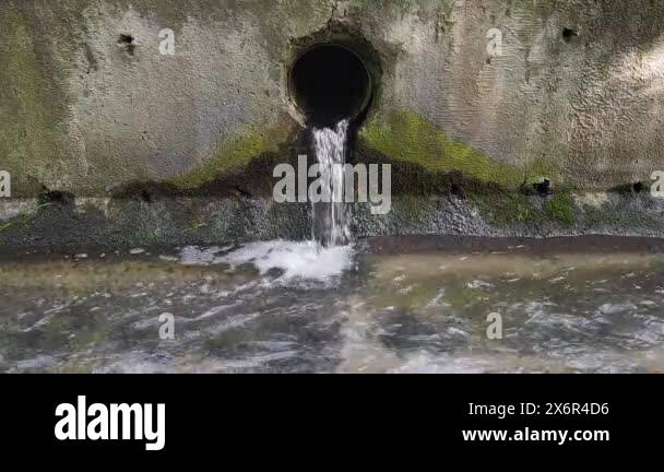 Water flows from the pipe into the river, drainage water in stormdrain ...