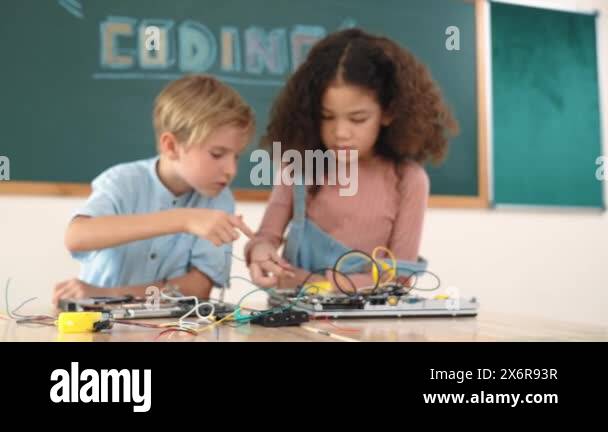 Girl standing while fixing electronic board by using screwdriver ...