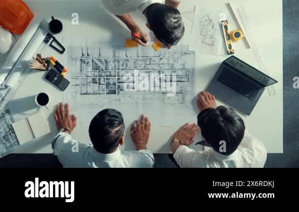 Top down aerial view of interior designer writing at sticky note while ...