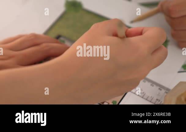 A video of architect using ruler and pencil to measure blueprint scale ...